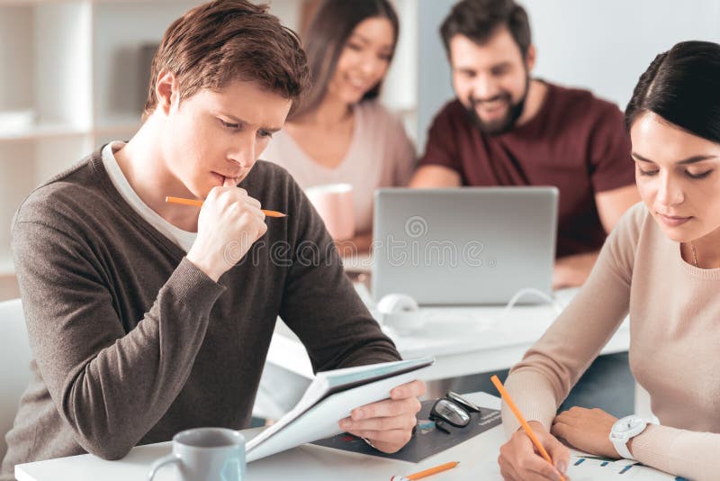 Nice Thoughtful Student Looking at His Notes Stock Image - Image of ...