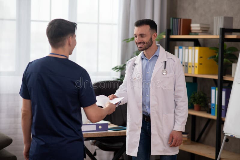 Bearded Head Doctor Shaking Hands with Young Intern Stock Image - Image ...