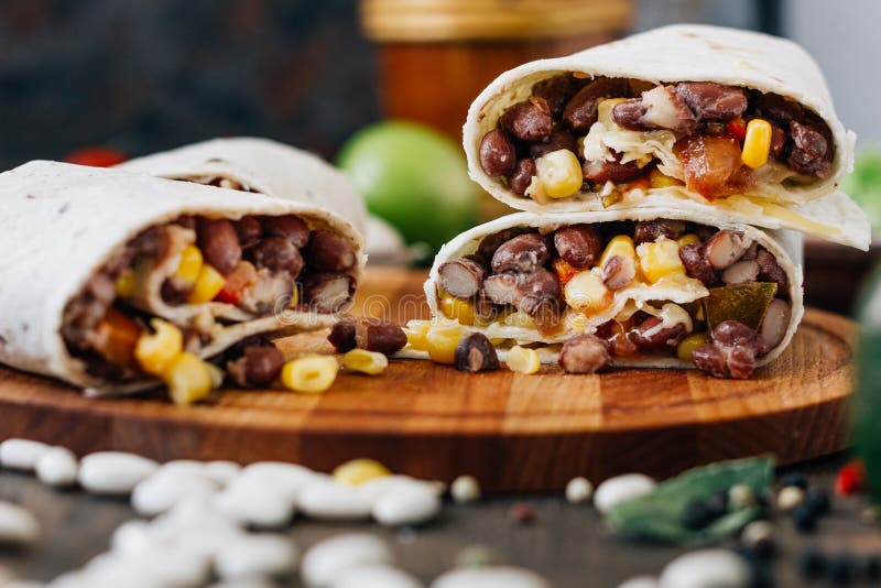 Nice Vegetarian Burrito Over Black Table on Wooden Board. Stock Photo ...