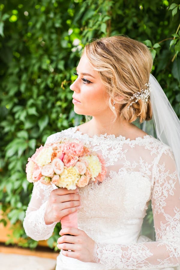 Nice Wedding Bouquet in the Hands of the Bride Stock Photo - Image of ...