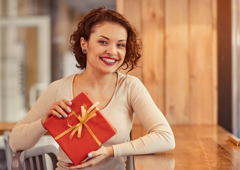 Nice woman holding present stock photo. Image of gladness - 68164418