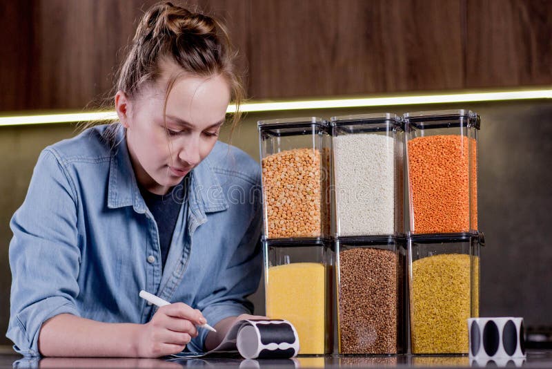 Nice Woman Organizes the Placement of Food in Plastic Cans. Woman Signs ...