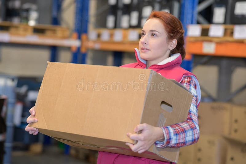 Young woman carrying box stock image. Image of carton - 104147795