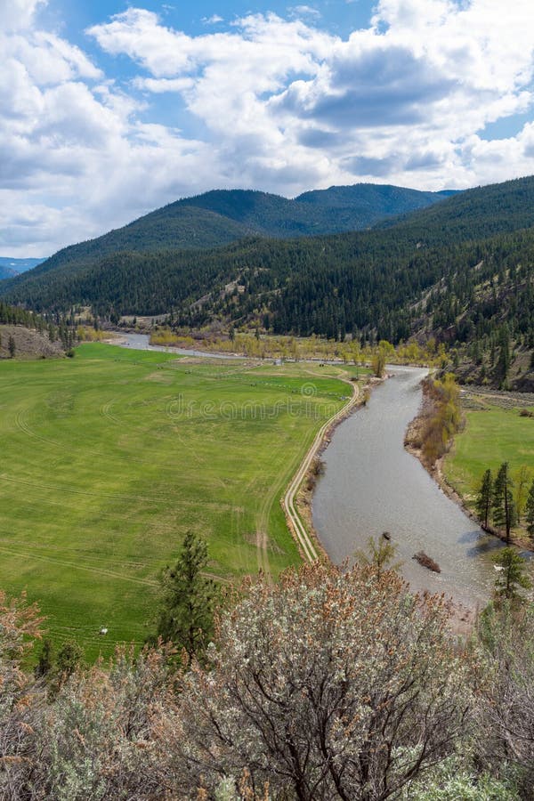 The Nicola River Runs by a Farm Field in British Columbia, Canada Stock ...