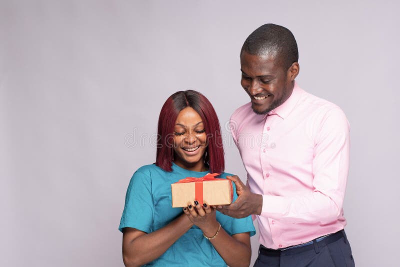 Nigerian Female Receiving a Present from a Man Stock Image - Image of ...