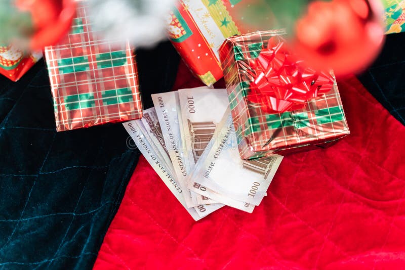 Nigerian Naira Notes Under Christmas Tree with Wrapped Presents Stock ...