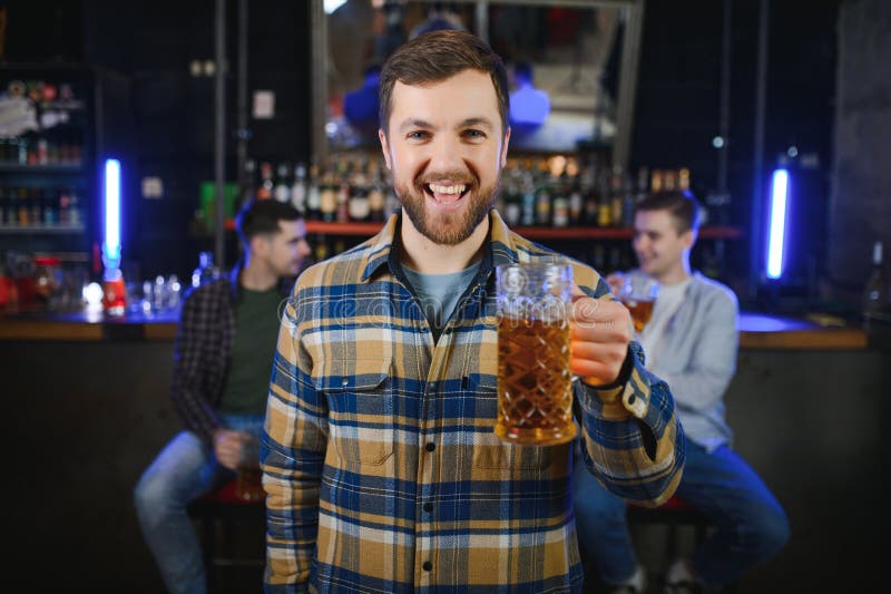Night in Bar. Portrait of Cheerful Men Drinking Beer at the Bar Stock ...