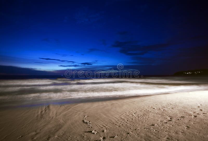 Midnight Blue Coastal Moonrise with Dramatic Sky and Rolling Waves ...