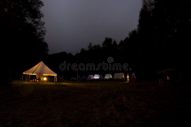 Night Camp with Burning Bonfire and Two Tents in Pine Forest Under ...