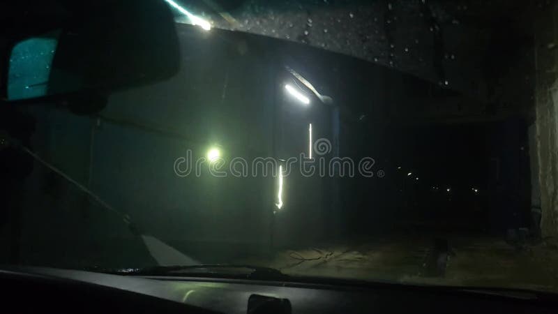 At Night at a Car Wash Washing the Windshield with a High Pressure ...