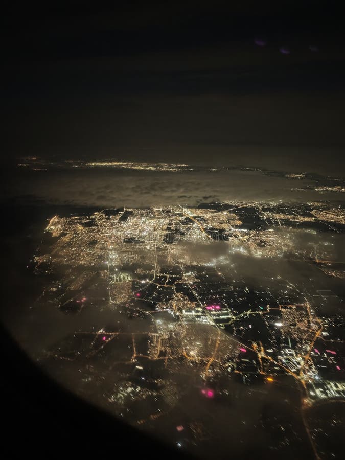 Night City Lights in Small Clouds from the Airplane Window Stock Image ...