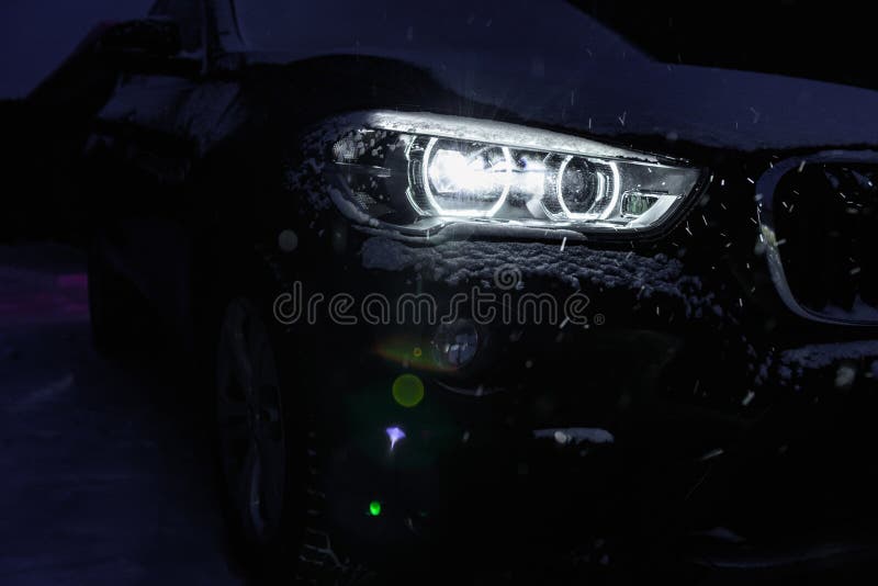 Night Driving in Winter. Front Headlight of Car Glowing in Dark in ...