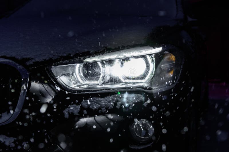 Night Driving in Winter. Front Headlight of Car Glowing in Dark in ...