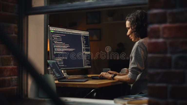 Night Home Office: Young Hispanic Woman is Working on Desktop Computer. Software Developer, E ...