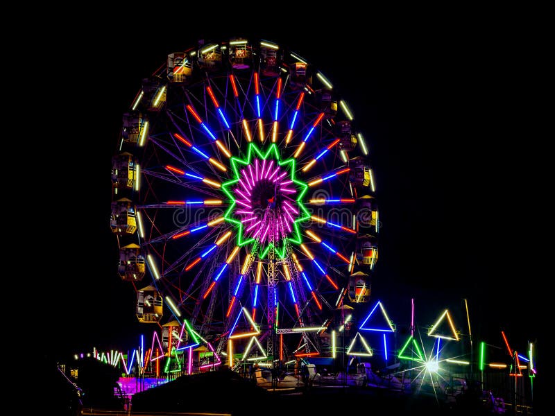 Night Image of Giant Ferris Wheel Illuminated and Spinning at Low Speed ...