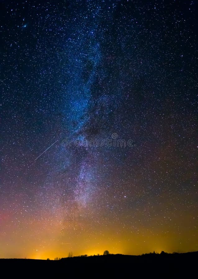 Night Landscape with Colorful Milky Way and Yellow Light in the Horizon ...