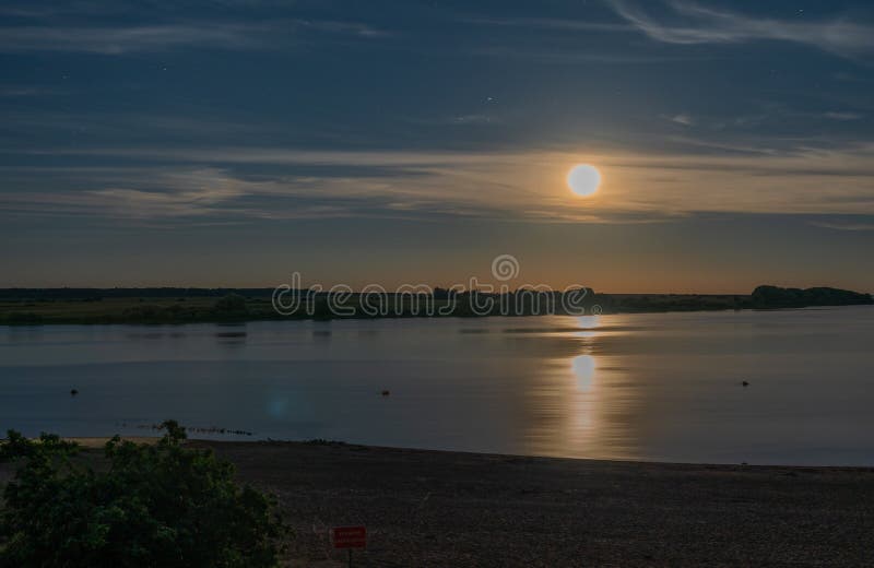 The Moon Over the River in the Starry Sky in Light Clouds. Night Summer ...