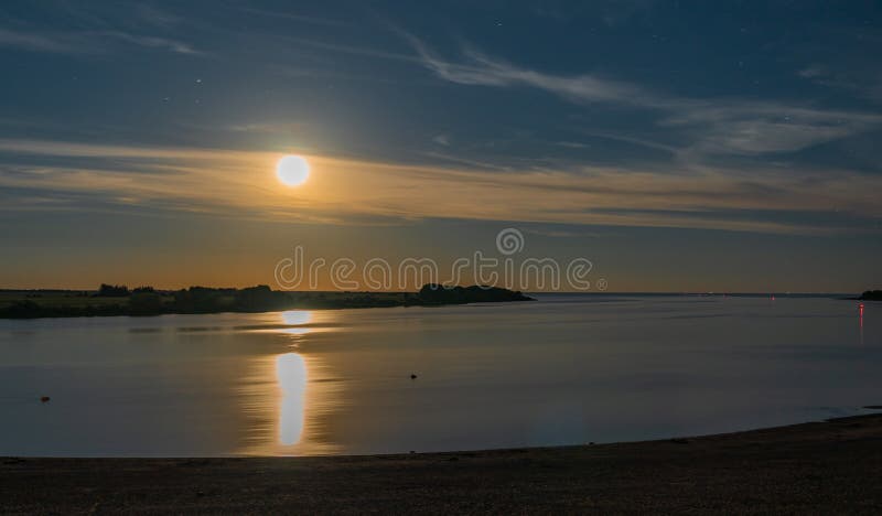 Night Landscape with the Moon Over the River. the Beach is Illuminated ...