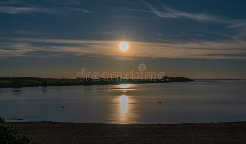 The Moon Over the River in the Starry Sky in Light Clouds. Night Summer ...