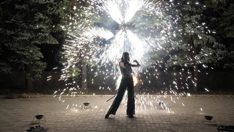 A Woman Dances with Fire Ropes Launching Fireworks. Fire Show. Stock ...