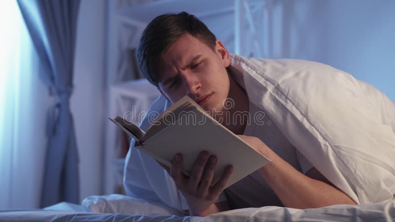 Night Reading Guy Falling Asleep with Book in Bed Stock Footage - Video ...