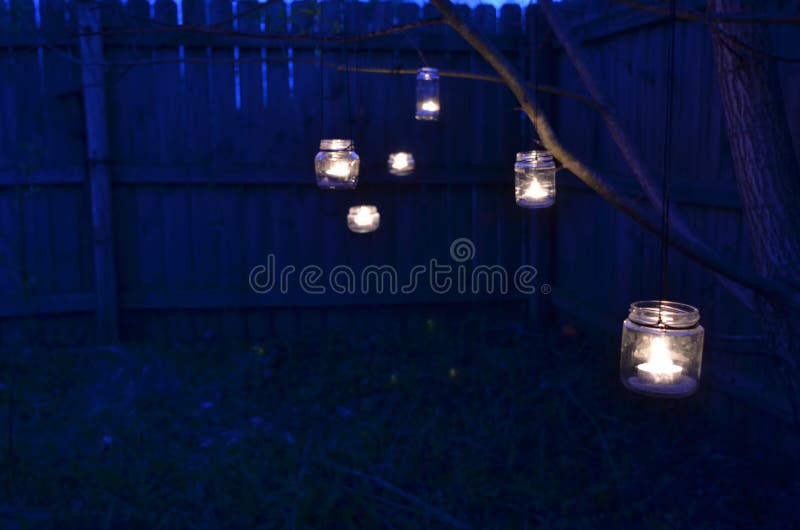 Night Scene Candles in Jars Hanging on Tree Branches Stock Photo ...
