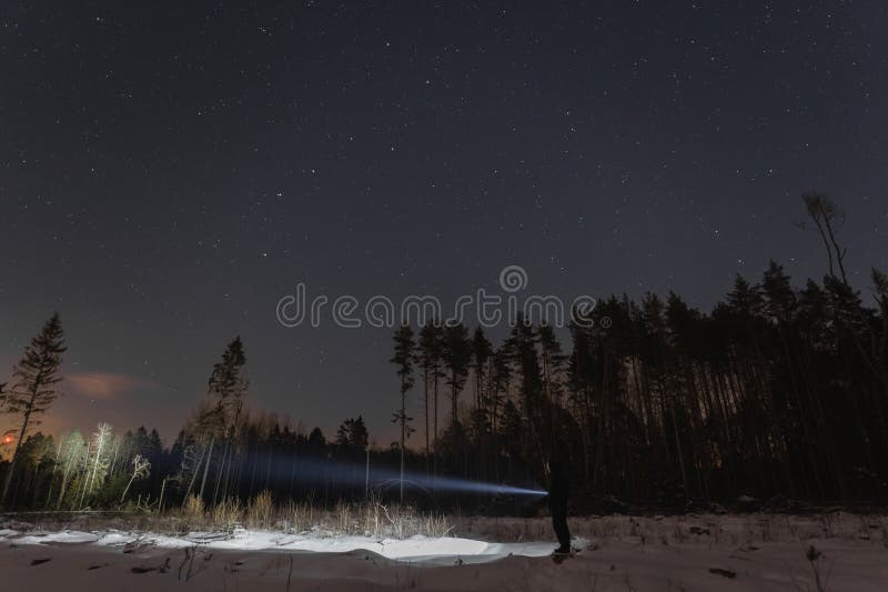 Night Scene, a Man with a Flashlight in the Winter Forest. Starry Sky ...