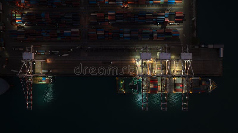Night Scene Shot from Above Commercial Port Loading and Unloading Cargo from Container Ship ...