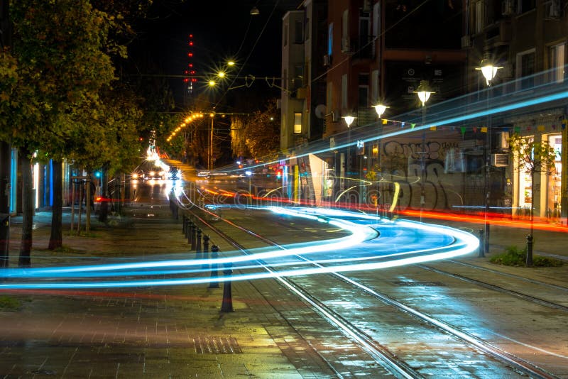 Night Scene of Tram in Traffic at Crossing with Lighttrail Motion Blur ...