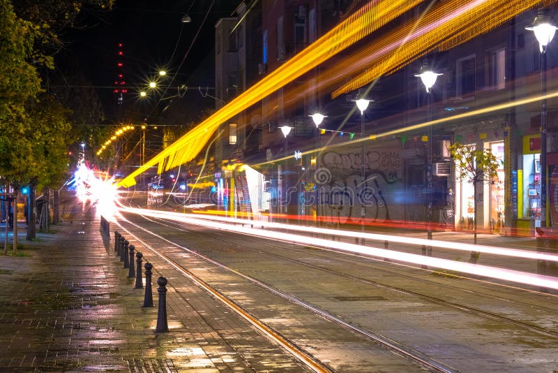 Night Scene of Tram in Traffic at Crossing with Lighttrail Motion Blur ...