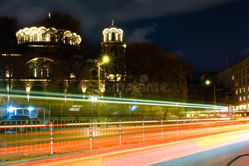 Night Scene of Tram in Traffic at Crossing with Lighttrail Motion Blur ...