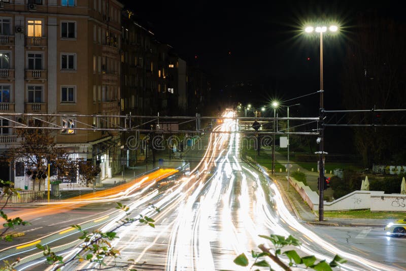Night Scene of Tram in Traffic at Crossing with Lighttrail Motion Blur ...