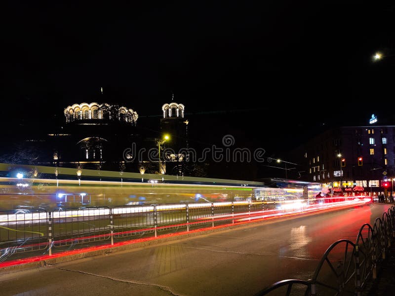Night Scene of Tram in Traffic at Crossing with Lighttrail Motion Blur ...