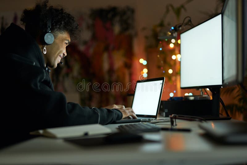 Night Shift. Smiling Young Guy Wearing Headset Sitting at the Table in ...