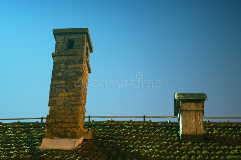 Night Shot of Two Vintage Chimneys on the Roof Stock Photo - Image of ...