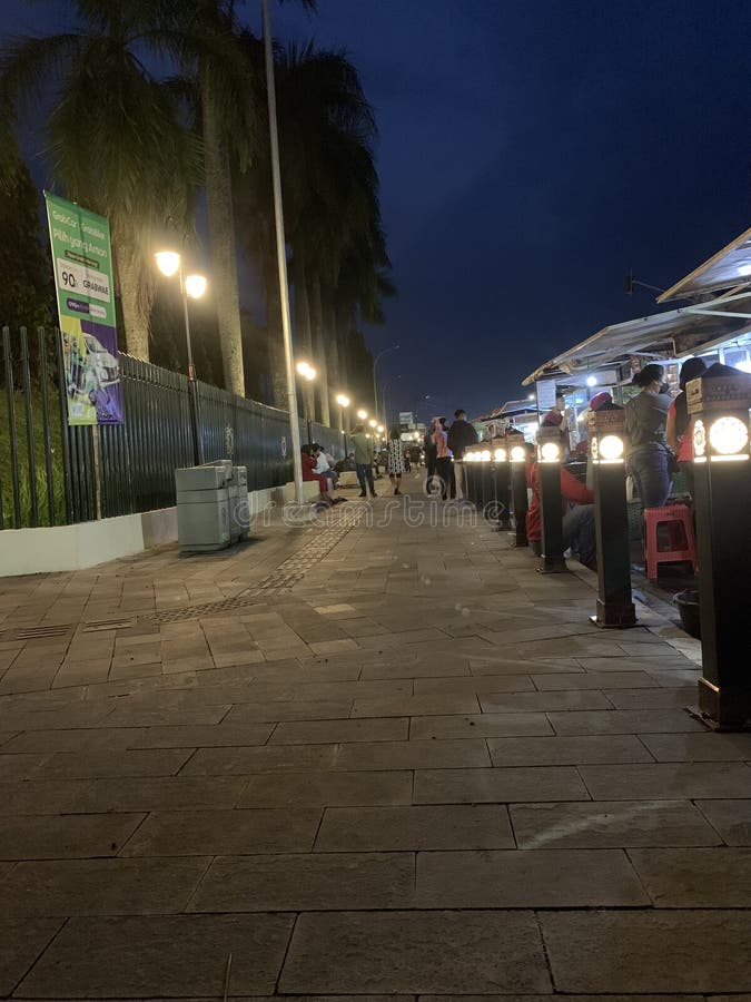 Night on the sidewalk editorial image. Image of silhouette - 261745910