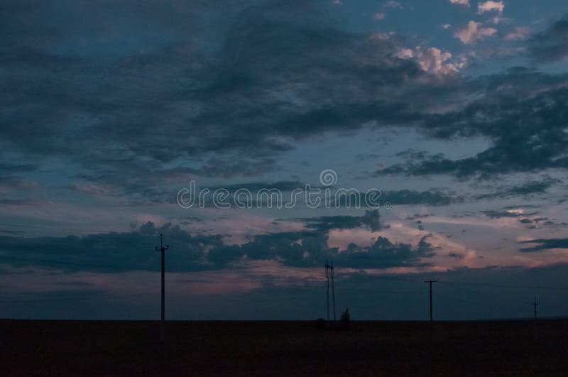 Summer. Field at Night. the Sun Set Over the Horizon. There are Pink ...