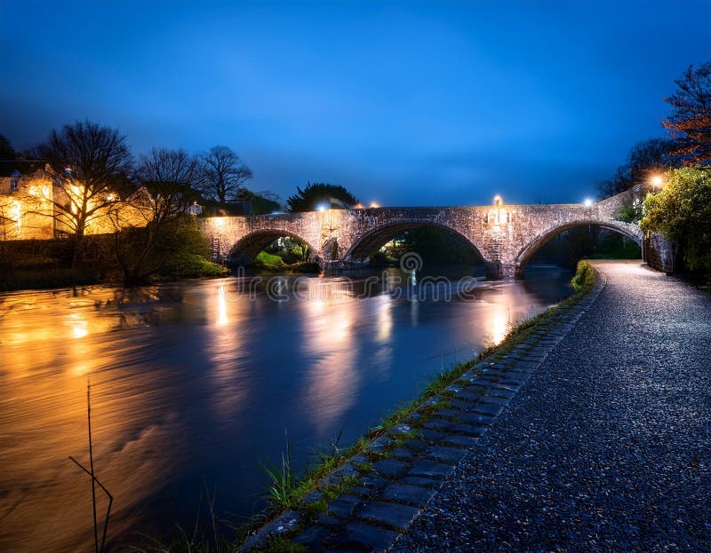 Night View of an Illuminated Irish Bridge and River Path, Inviting ...