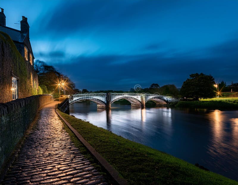 Night View of an Illuminated Irish Bridge and River Path, Inviting ...