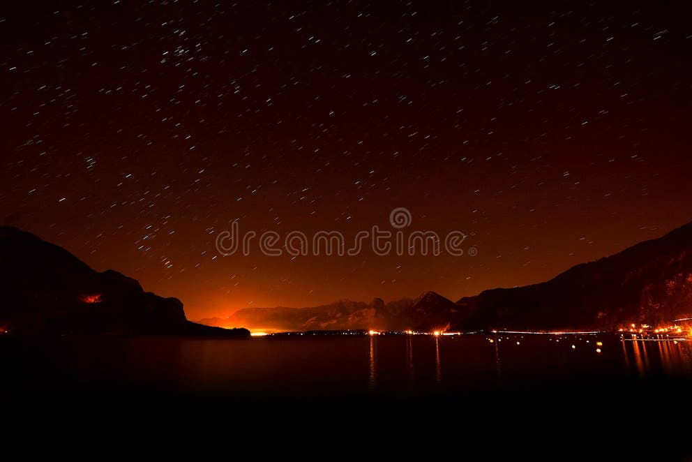 Night View of the Lake with the Lights on the Horizon and the Starry ...