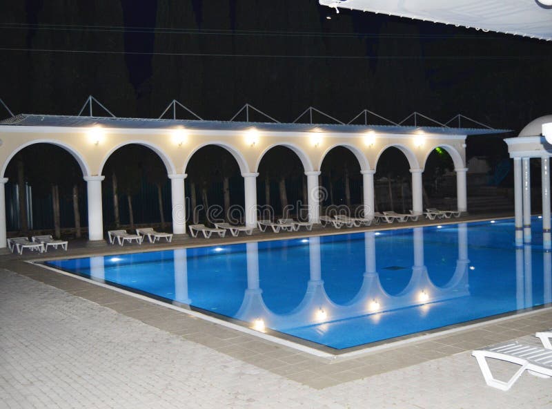Night View of the Luxurious Pool with Columns and Arches, Reflected in ...