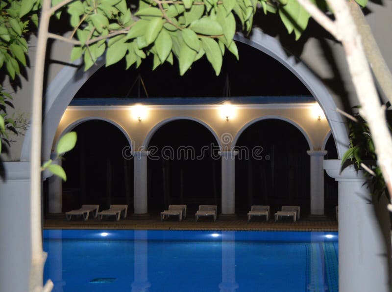 Night View of the Luxurious Pool with Columns and Arches, Reflected in ...