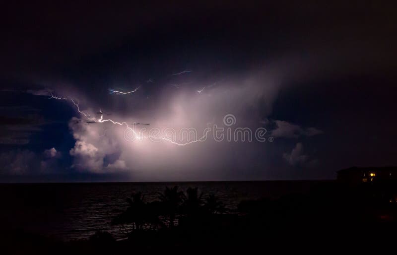 Night View of an Ocean Under the Mesmerizing Purple Sky with Lightning ...