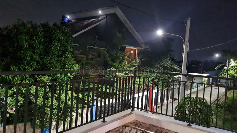 The Night View Over the Terrace of the House Which is Lit by the Lights ...