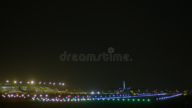 Nighttime Airplane Landing Revealing Illuminated Runway from Elevated ...