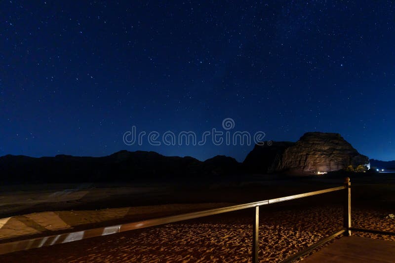 Nighttime Desert Dome Camping with Illuminated Pathways and a Starry ...
