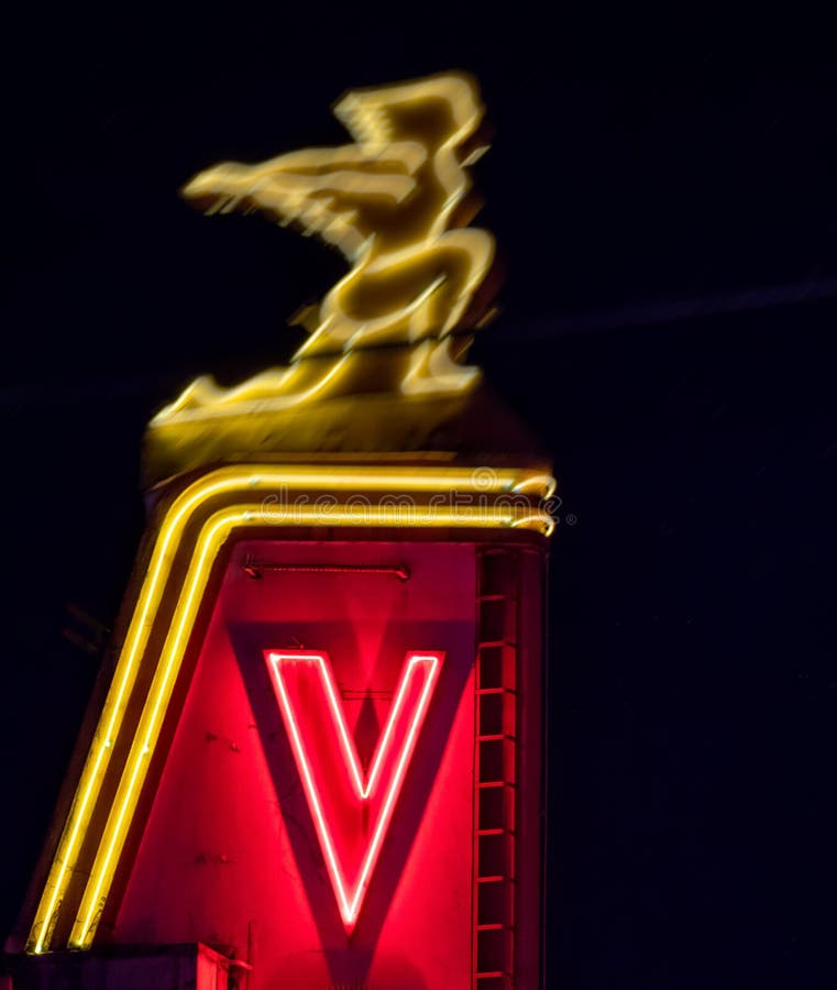 A Nighttime Image of a Neon Sculpture Portrays a Speeding Individual ...