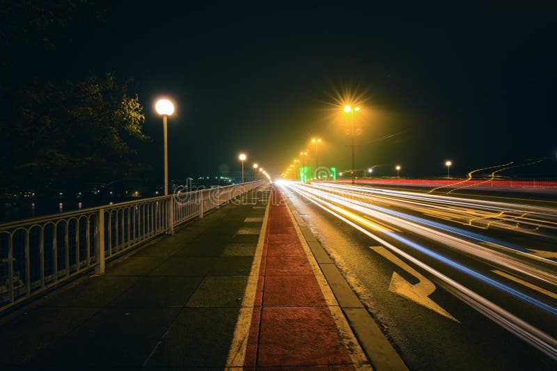 Nighttime Long Exposure Image of a Bridge Illuminated by the Bright ...