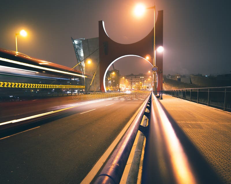 Nighttime Shot of a Road on a Bridge with an Arc-like Construction in ...