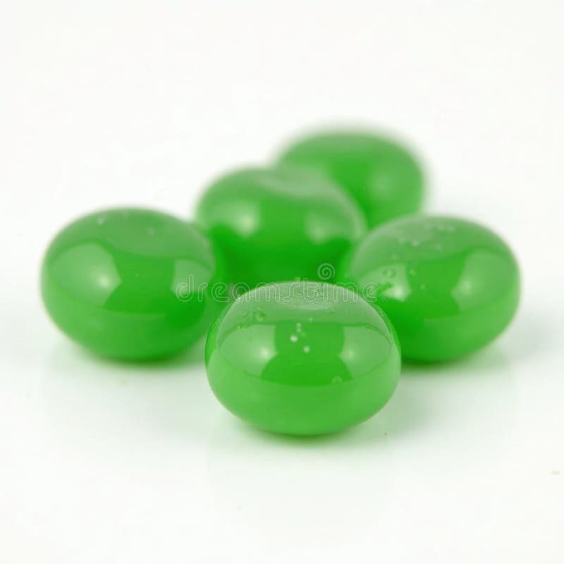 Nine Glossy, Green Bead-like Objects Arranged on a White Surface ...